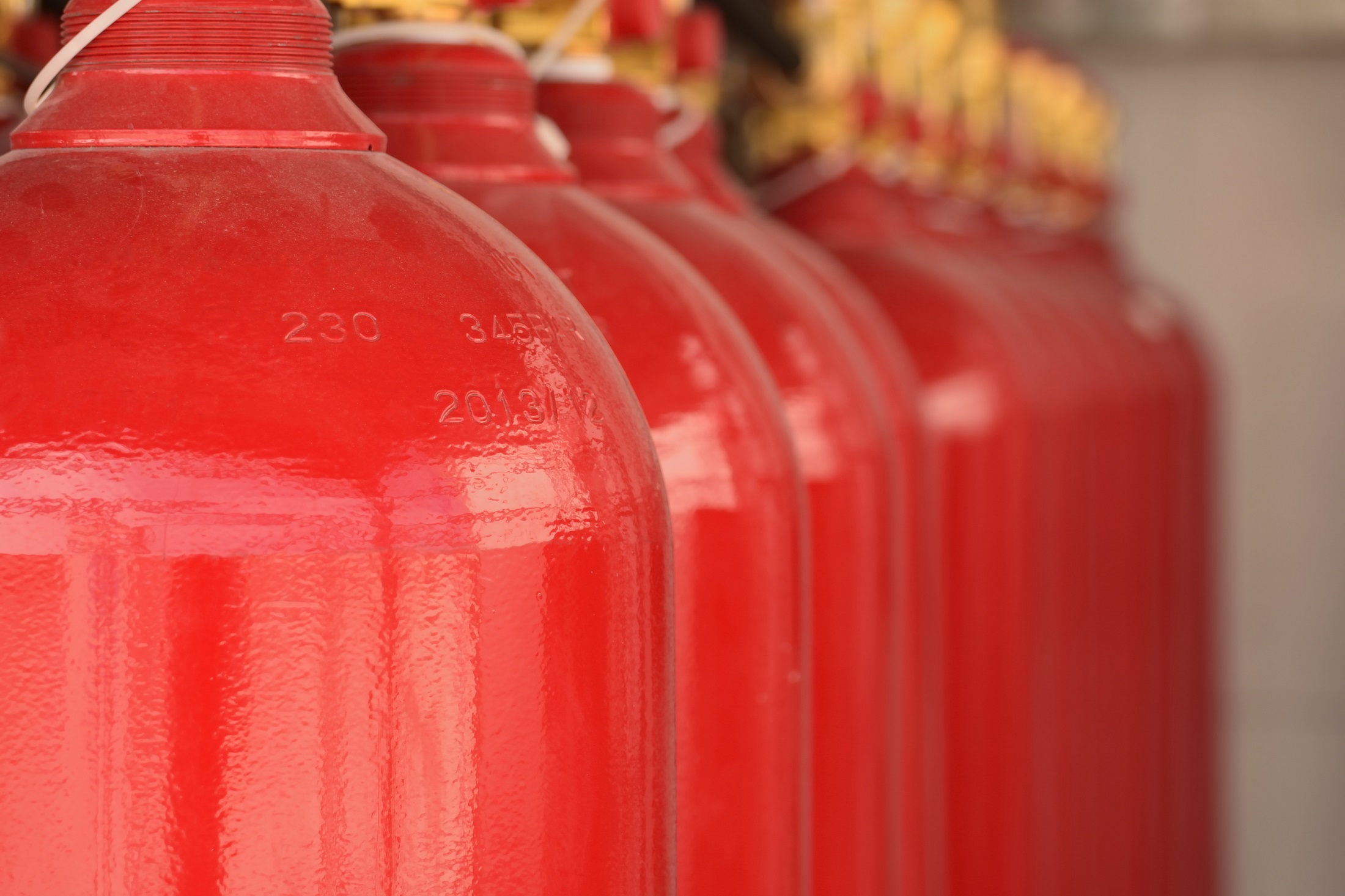 How should gas cylinders be stored?
